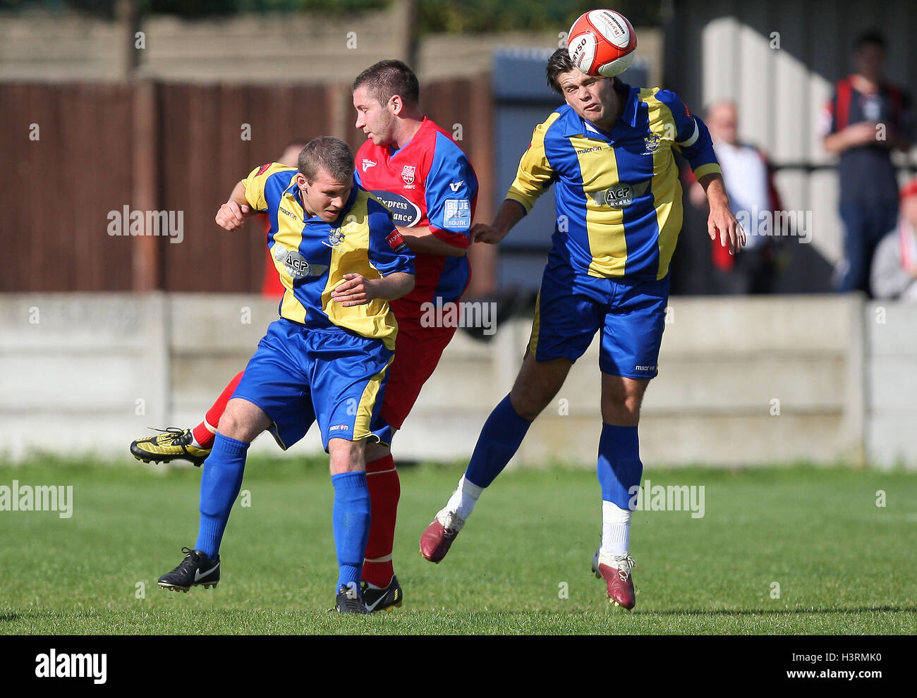 Richard Oxby (L) and Matt Toms of Romford combine to thwart Ian Hodges ...