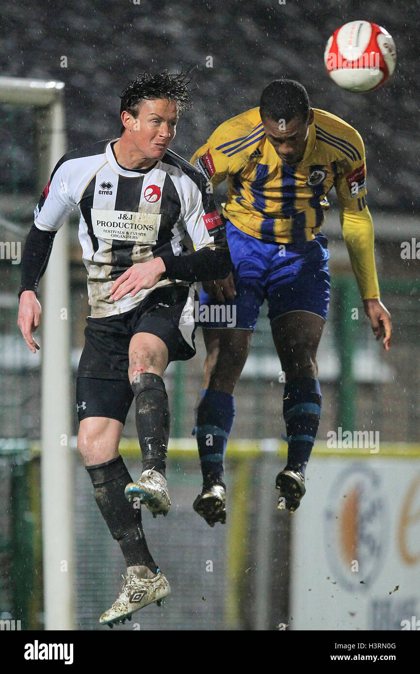 Danny Barber of Heybridge heads clear from Ryan Imbert of Romford ...