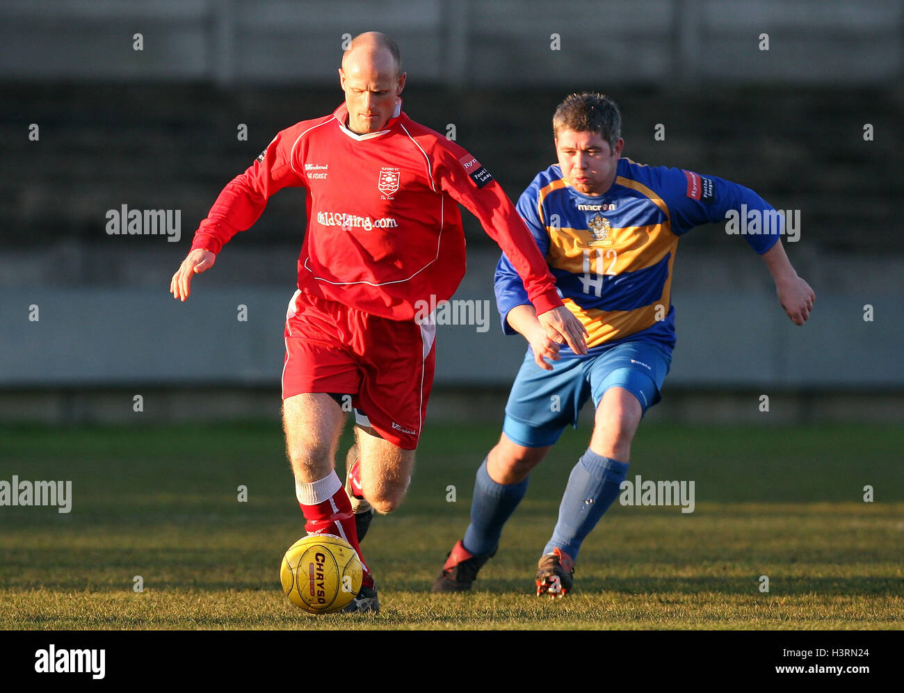 Cooper of Ilford shields the ball from James Gammons of Romford ...