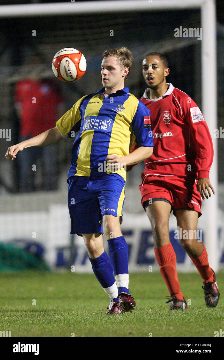 Jack Barry of Romford shields the ball from Karl Blake of Ilford ...
