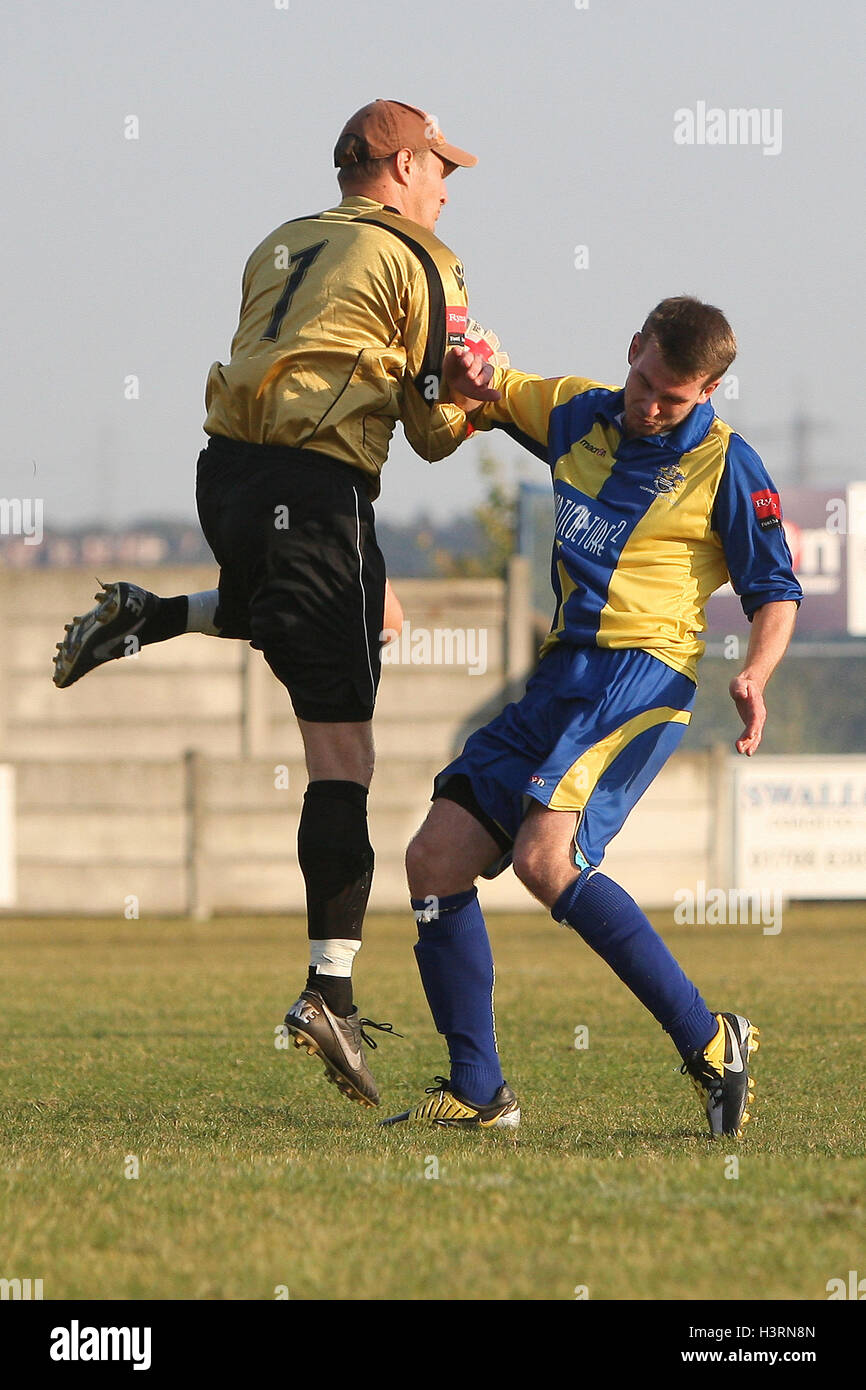 Richard Oxby of Romford challenges Leiston goalkeeper Louis Johnson ...