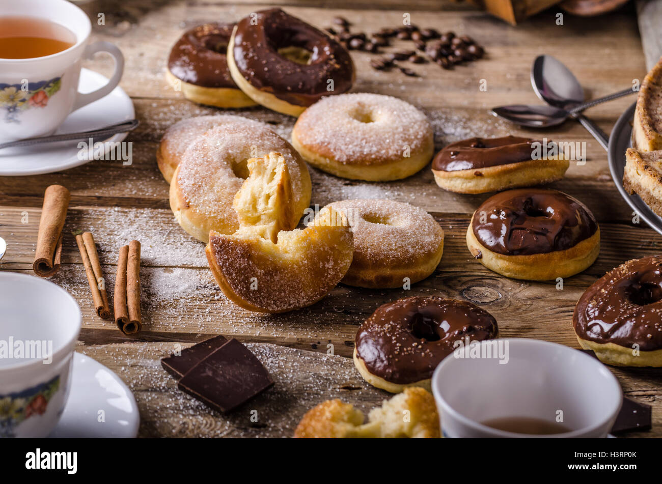 Old style donuts with sugar and dark chocolate, whole table, place for ...