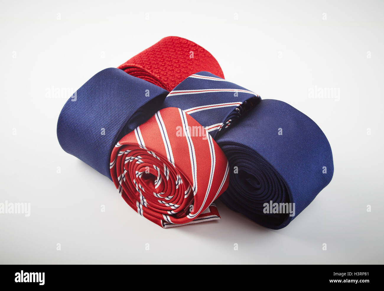 Assortment of ties rolled up Stock Photo - Alamy