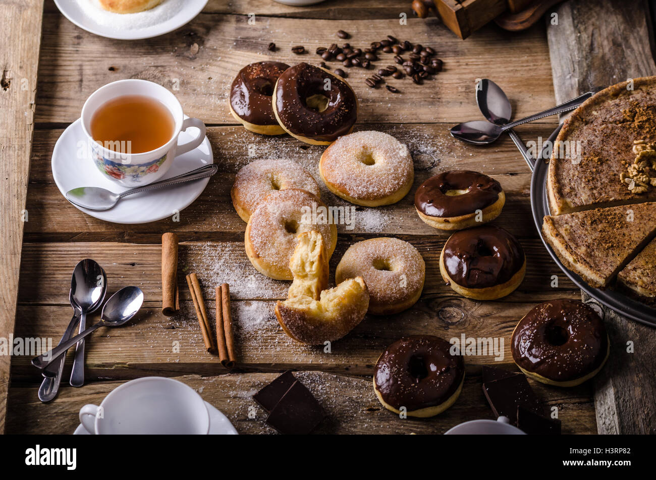 Old style donuts with sugar and dark chocolate, whole table, place for ...
