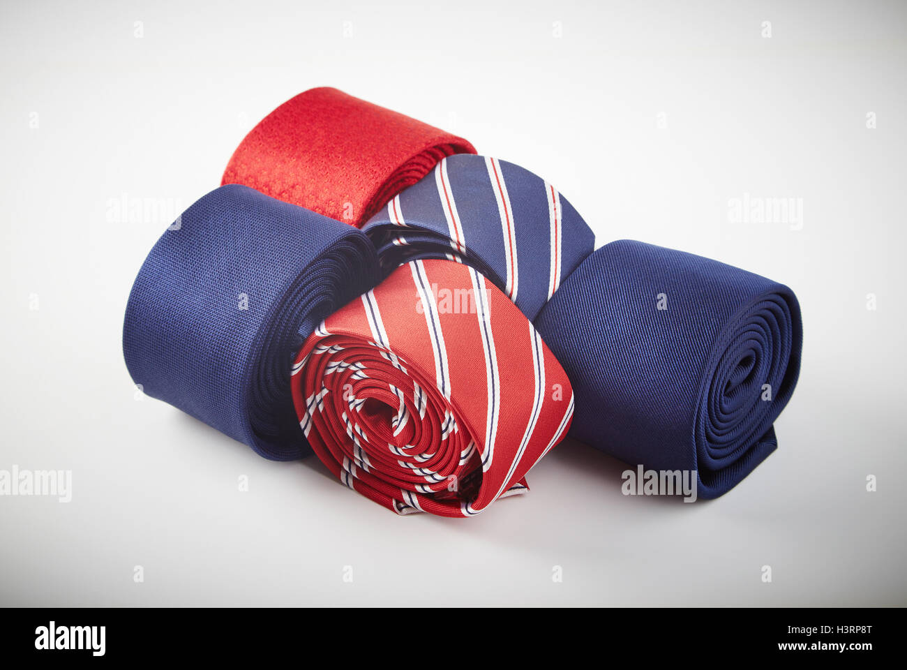 Assortment of ties rolled up Stock Photo - Alamy