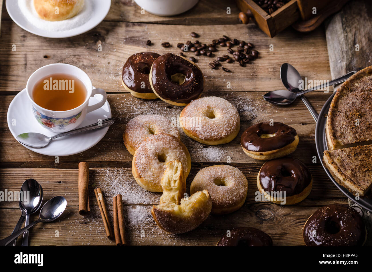 Old style donuts with sugar and dark chocolate, whole table, place for ...