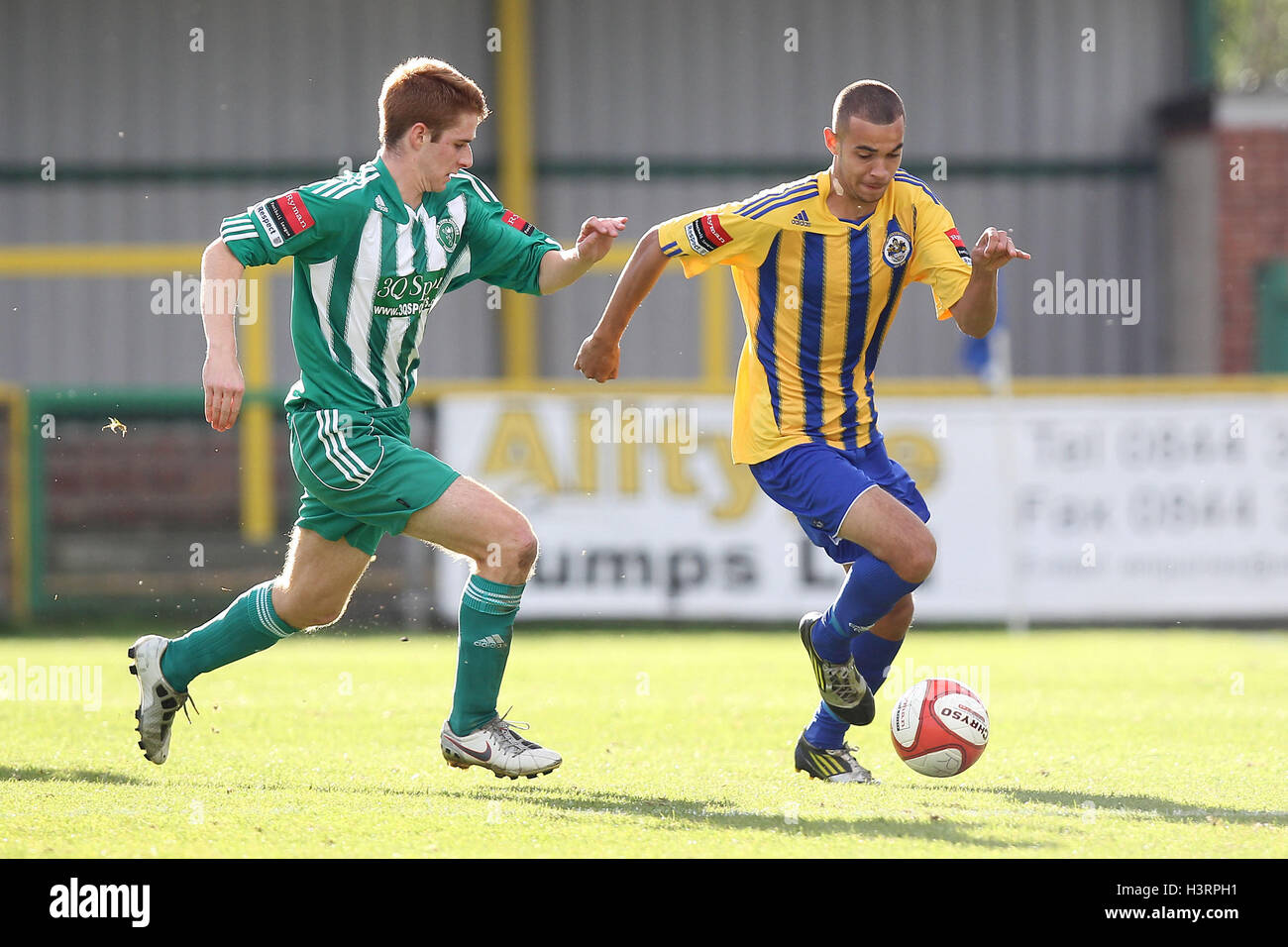 Reece Hewitt of Romford in a race for the ball with Joe Asensi of Soham ...
