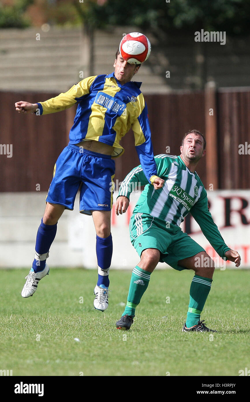 James Ishmail of Romford rises to beat Andrew Furnell to the ball ...