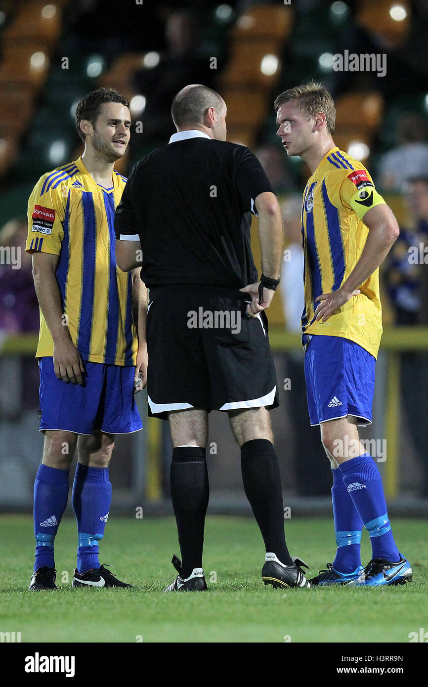 Referee Neil West speaks to Jack Barry (R) and Paul Clayton of Romford ...
