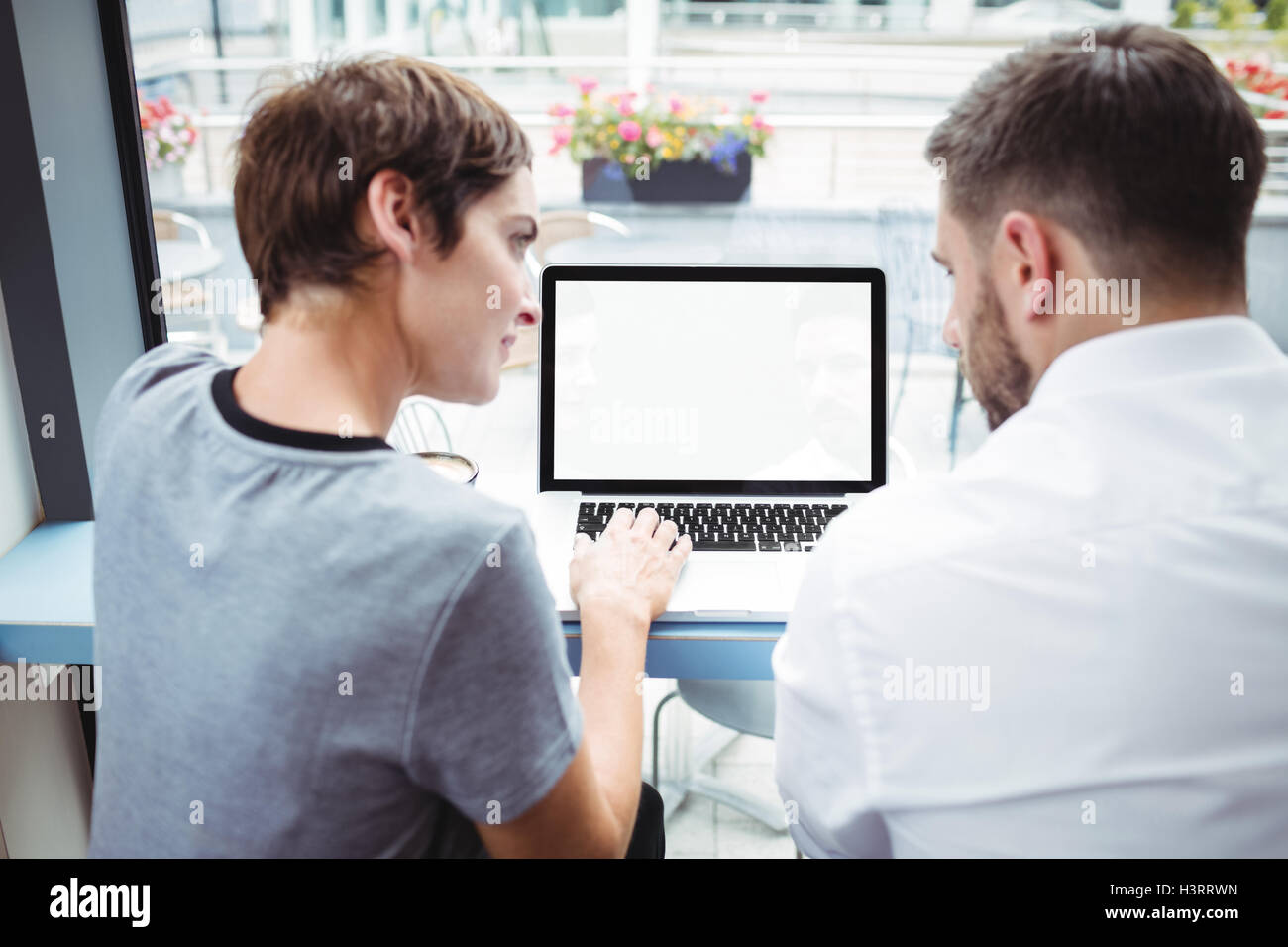 Businesspeople discussing over laptop Stock Photo - Alamy