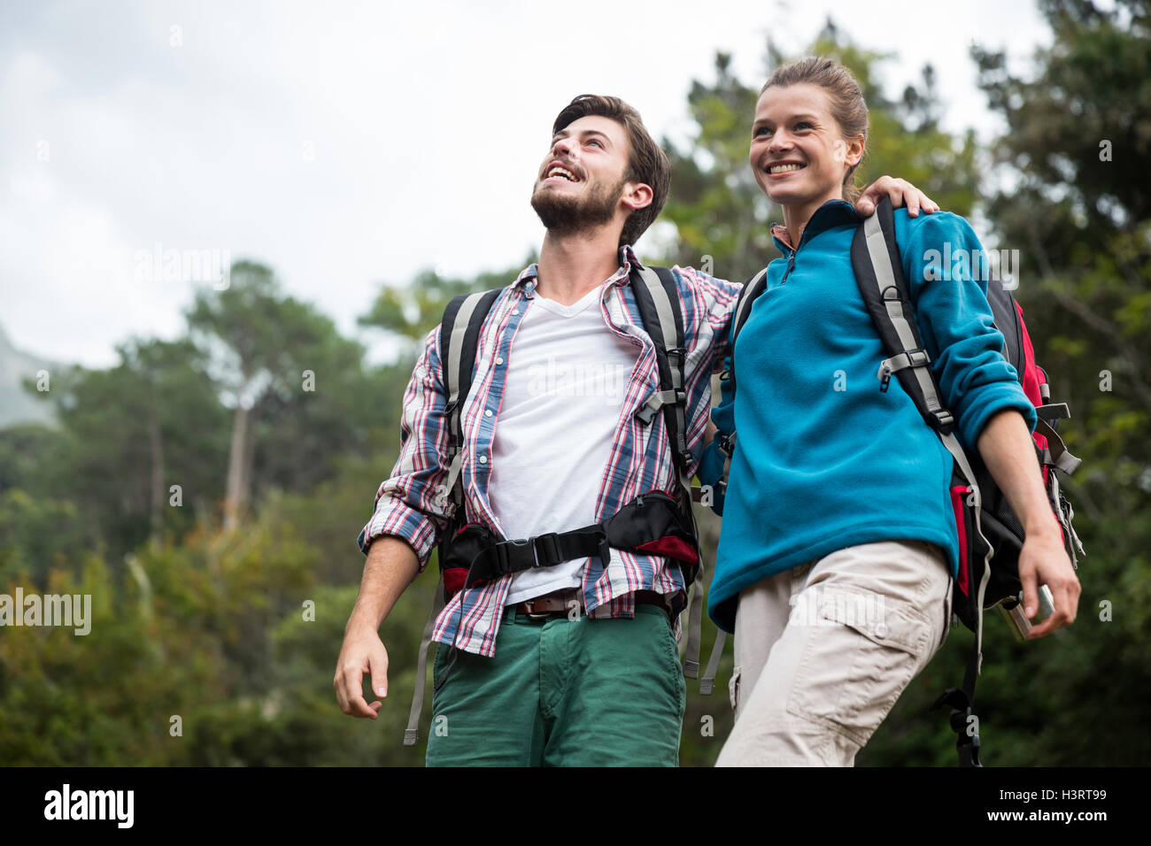 Hiker couple hiking in forest Stock Photo - Alamy