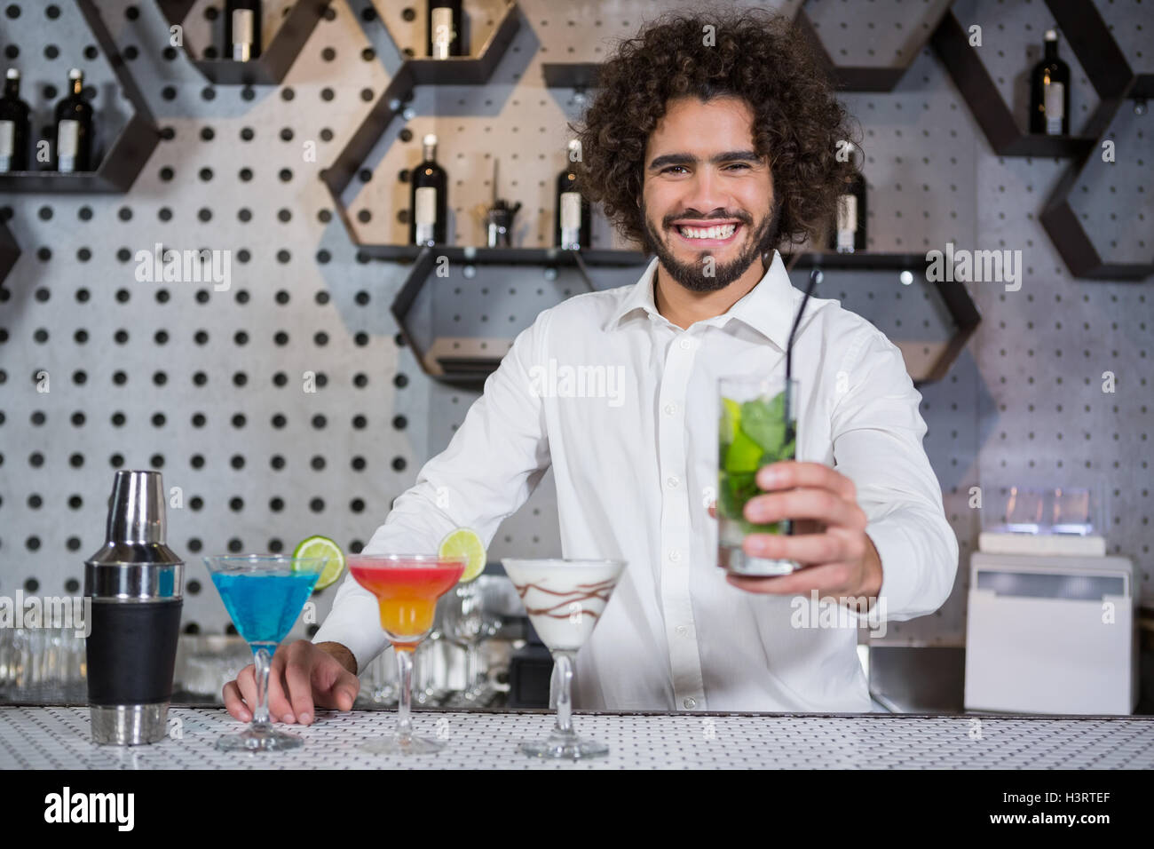 Bartender serving glass of gin Stock Photo - Alamy