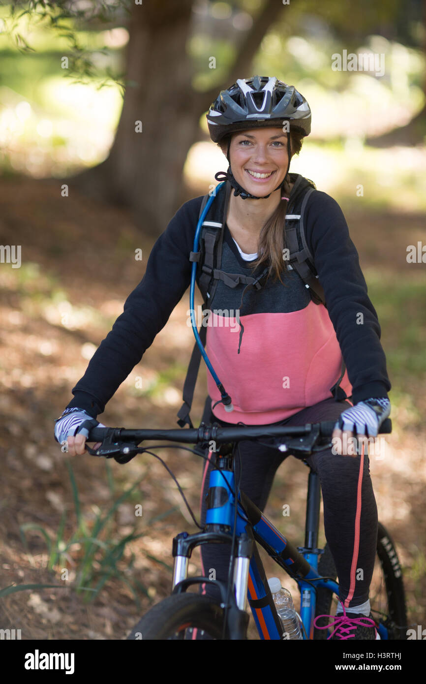 Female biker with mountain bike in countryside Stock Photo - Alamy