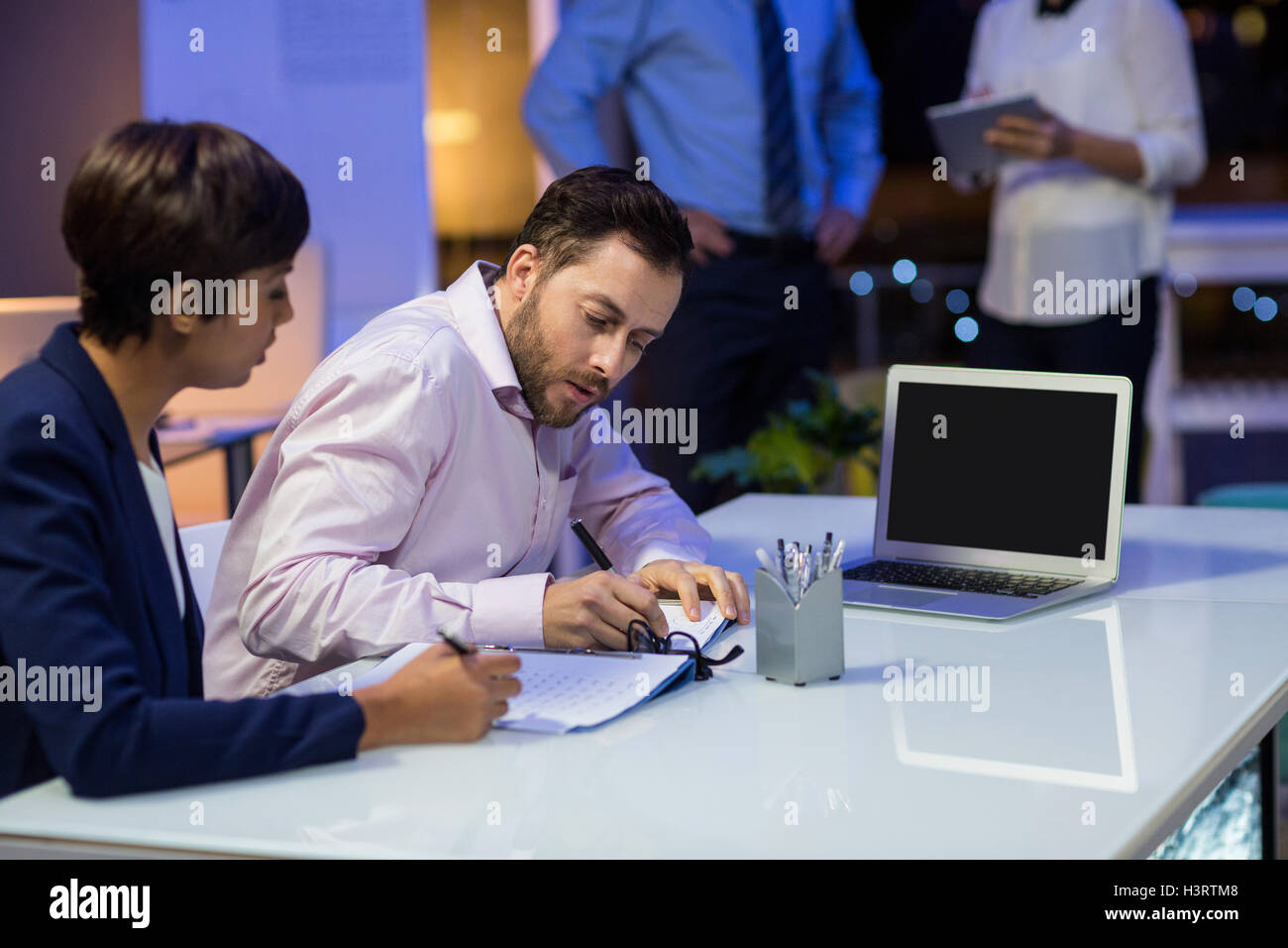 Businesspeople preparing document in conference room Stock Photo - Alamy