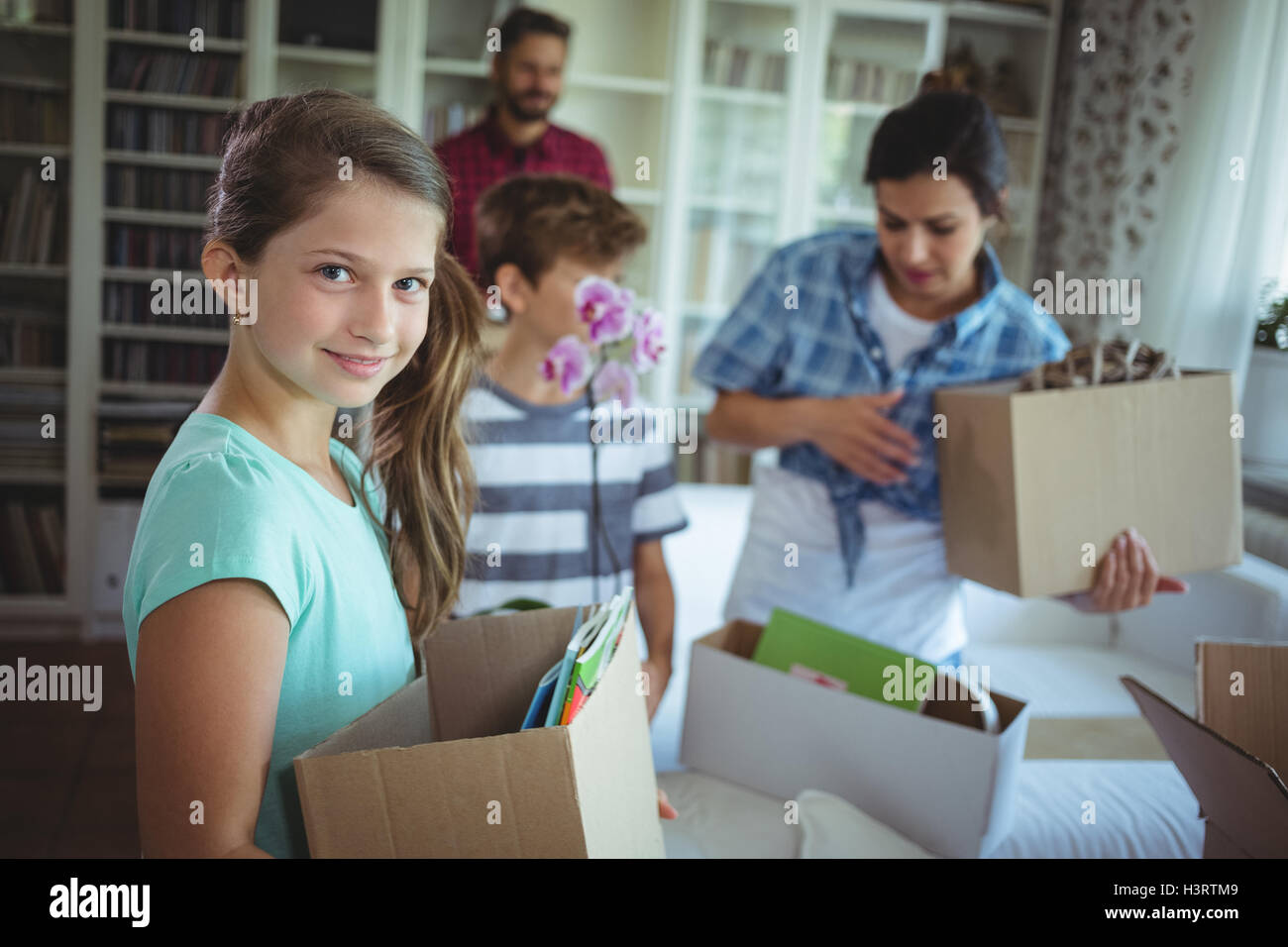 Family unpacking cartons together Stock Photo - Alamy