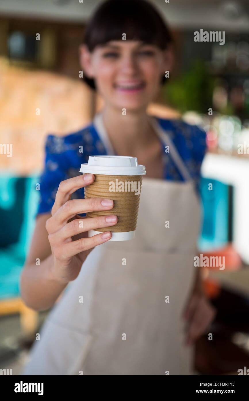 Waitress offering a cup of coffee Stock Photo - Alamy