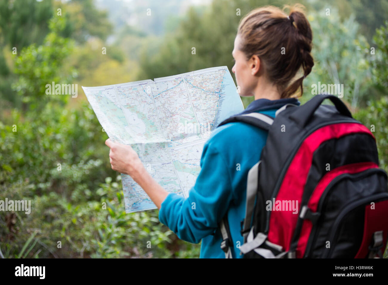 Female hiker looking at map Stock Photo - Alamy