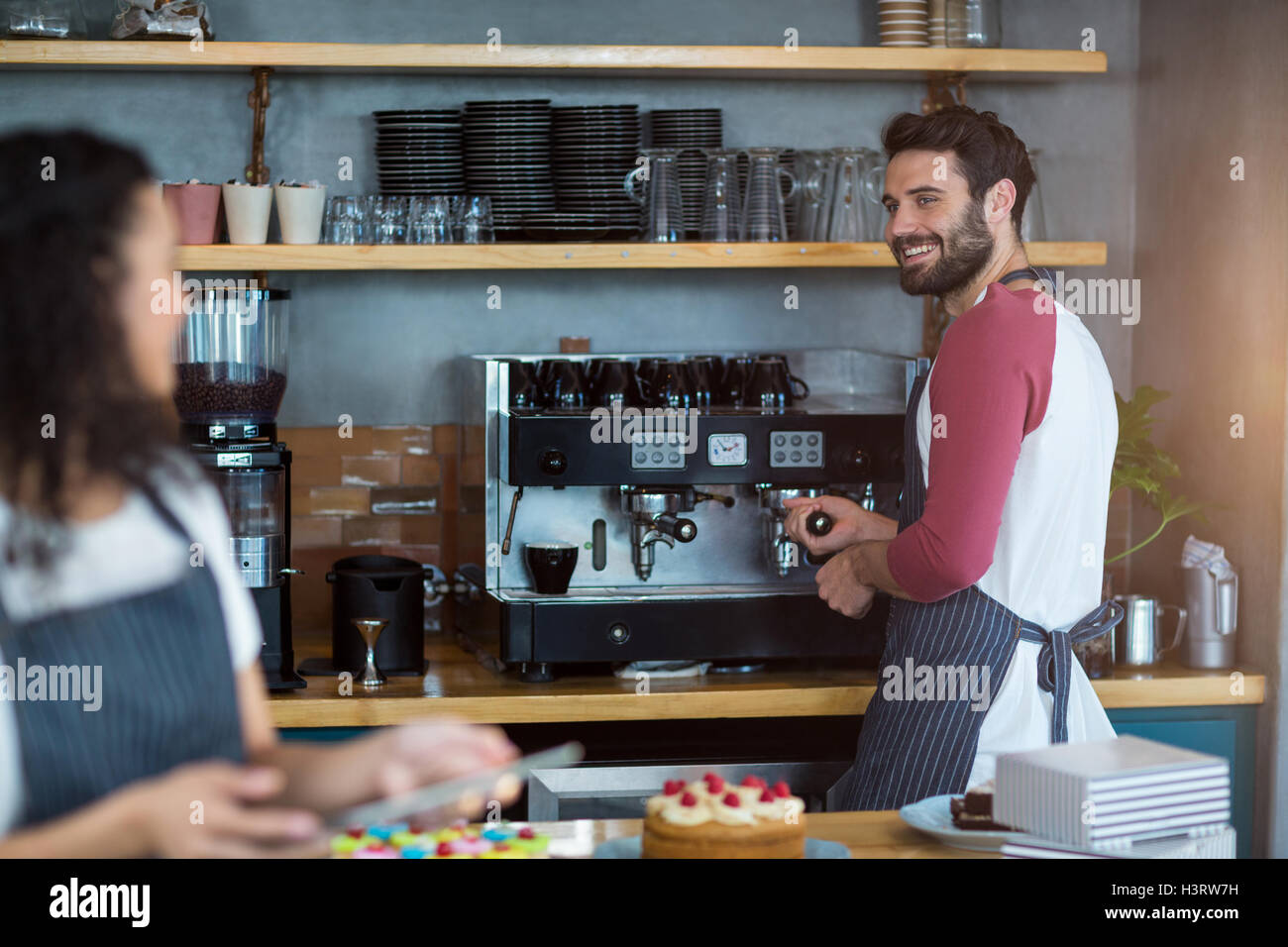 Waiter and waitress working in kitchen at caf├⌐ Stock Photo - Alamy