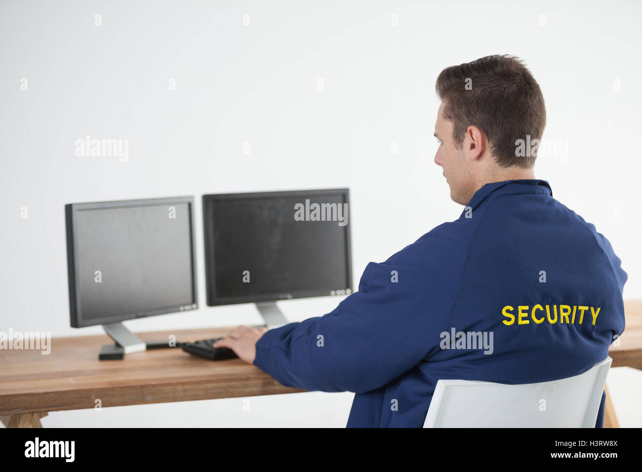 Security officer using computer Stock Photo - Alamy