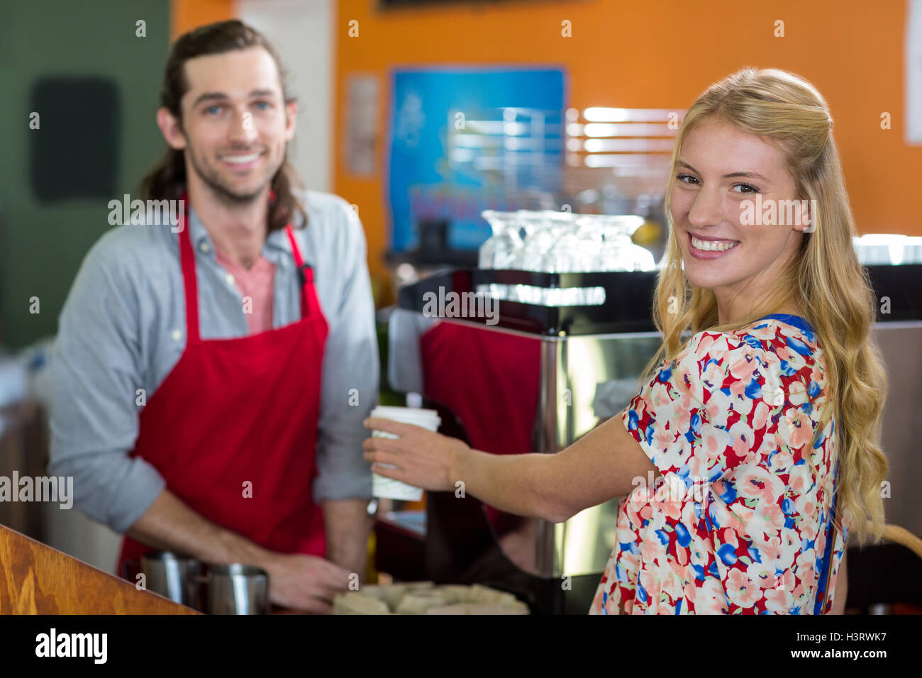 Portrait of smiling woman and male staff at caf├⌐ counter Stock Photo ...