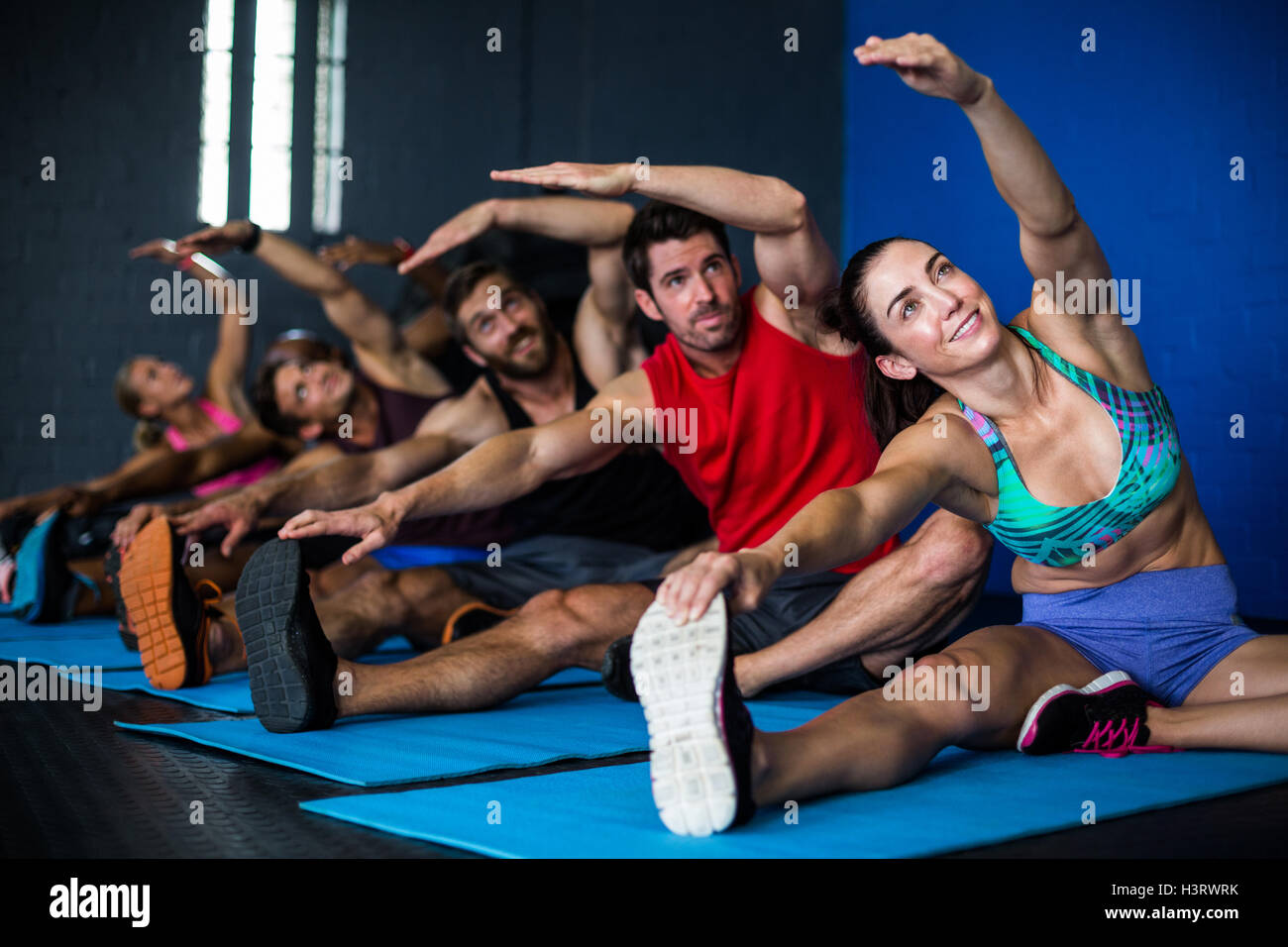 Young friends doing stretching exercise Stock Photo - Alamy