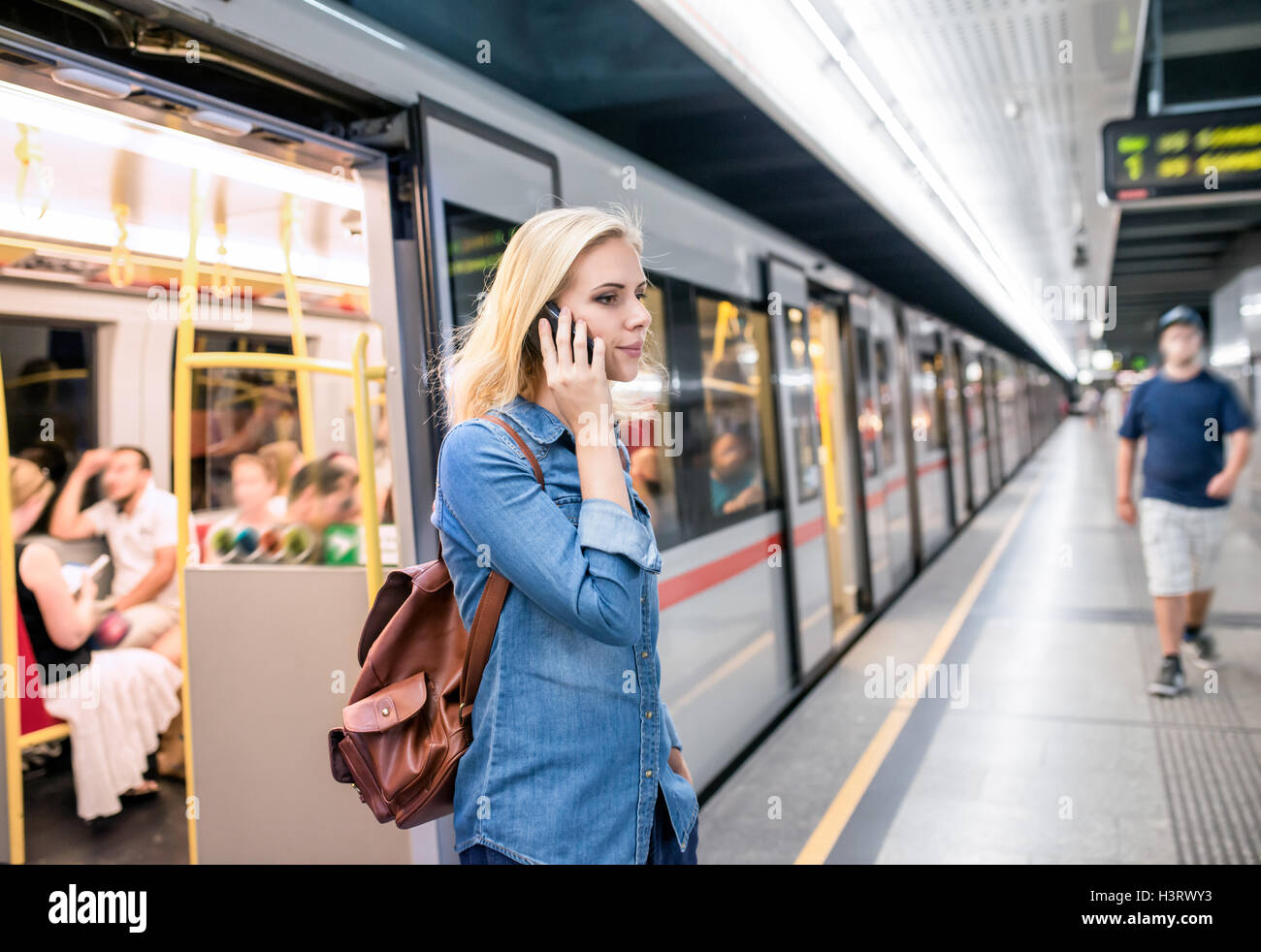 Woman making phone call at the underground platform Stock Photo - Alamy