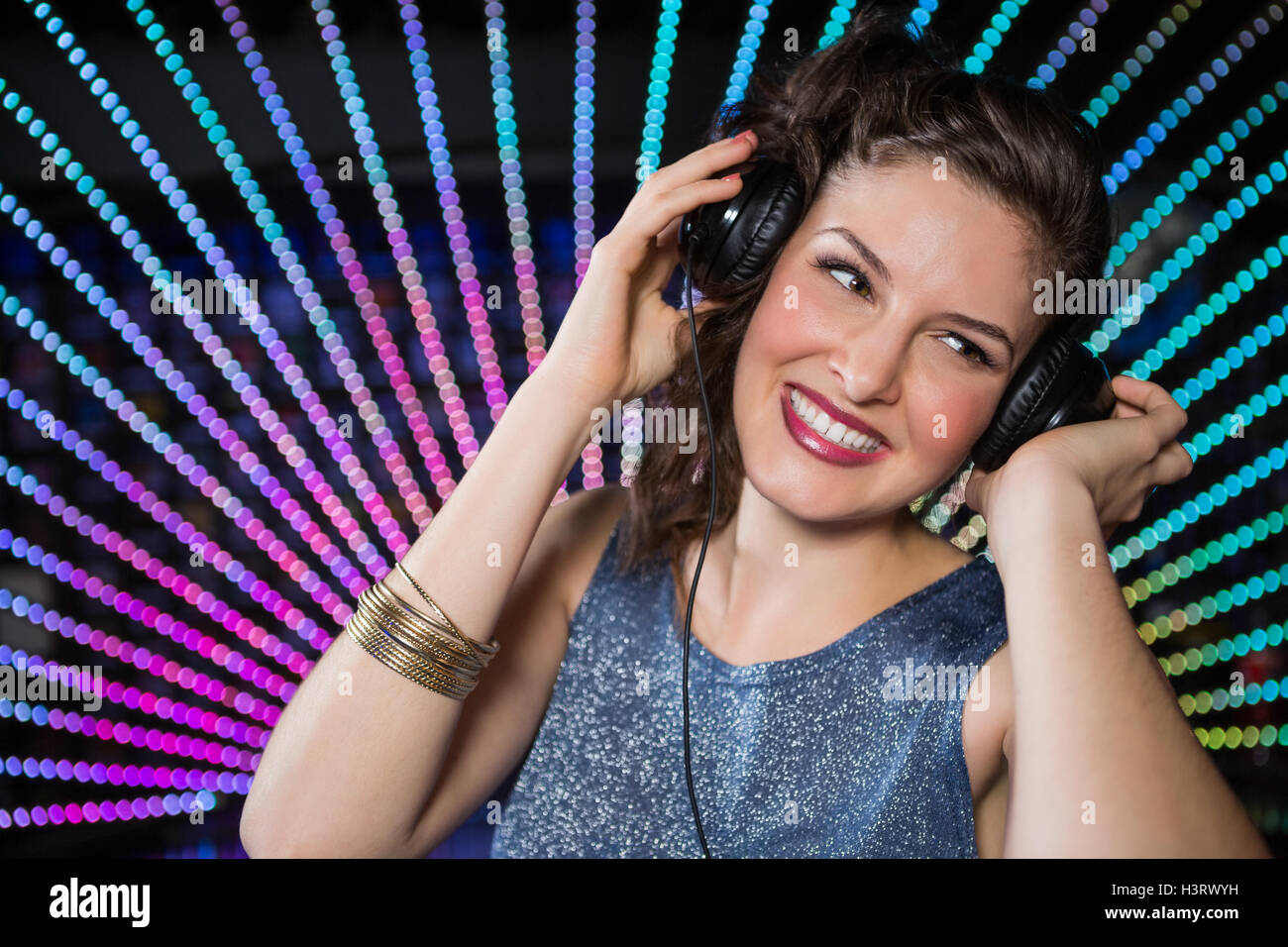 Pretty female DJ playing music Stock Photo - Alamy