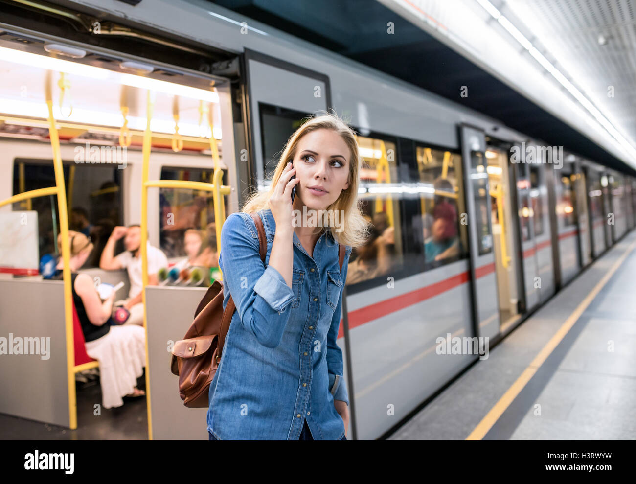 Woman making phone call at the underground platform Stock Photo - Alamy