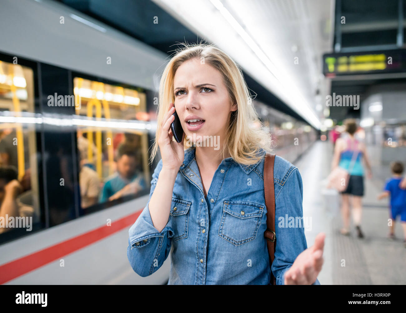 Woman making phone call at the underground platform, waiting Stock ...