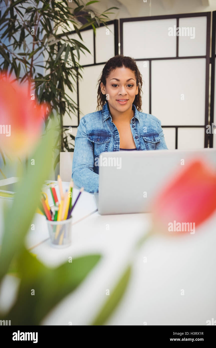 Confident graphic designer at desk with laptop Stock Photo - Alamy
