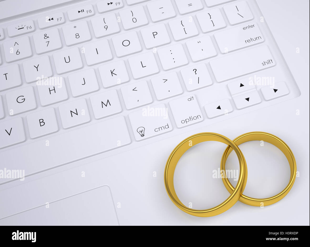 Two gold rings on the keyboard Stock Photo - Alamy