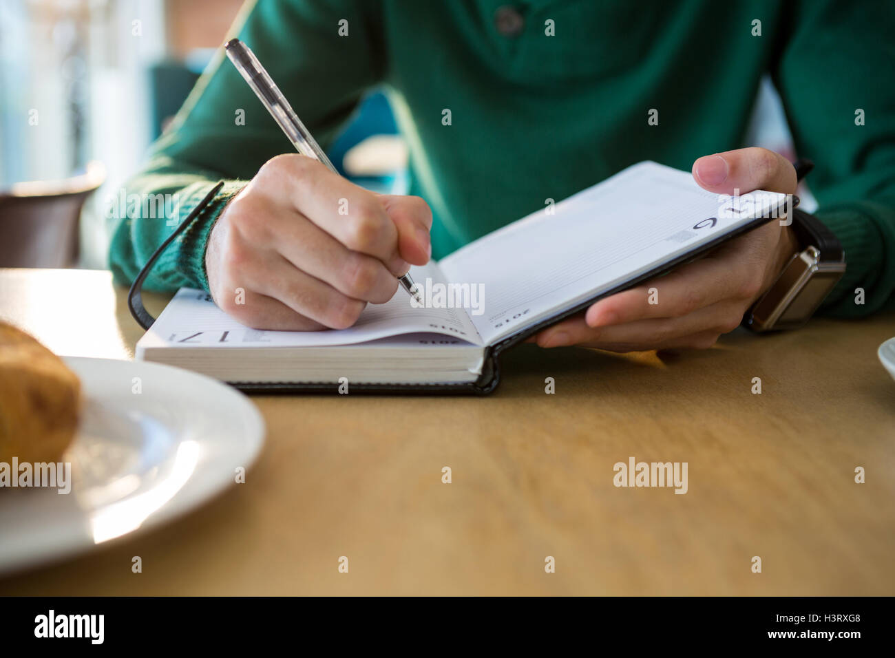 Man writing in diary Stock Photo - Alamy