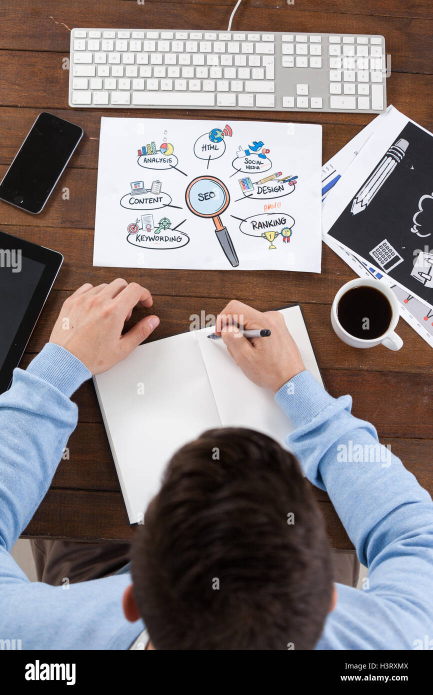 Man taking notes in diary Stock Photo - Alamy