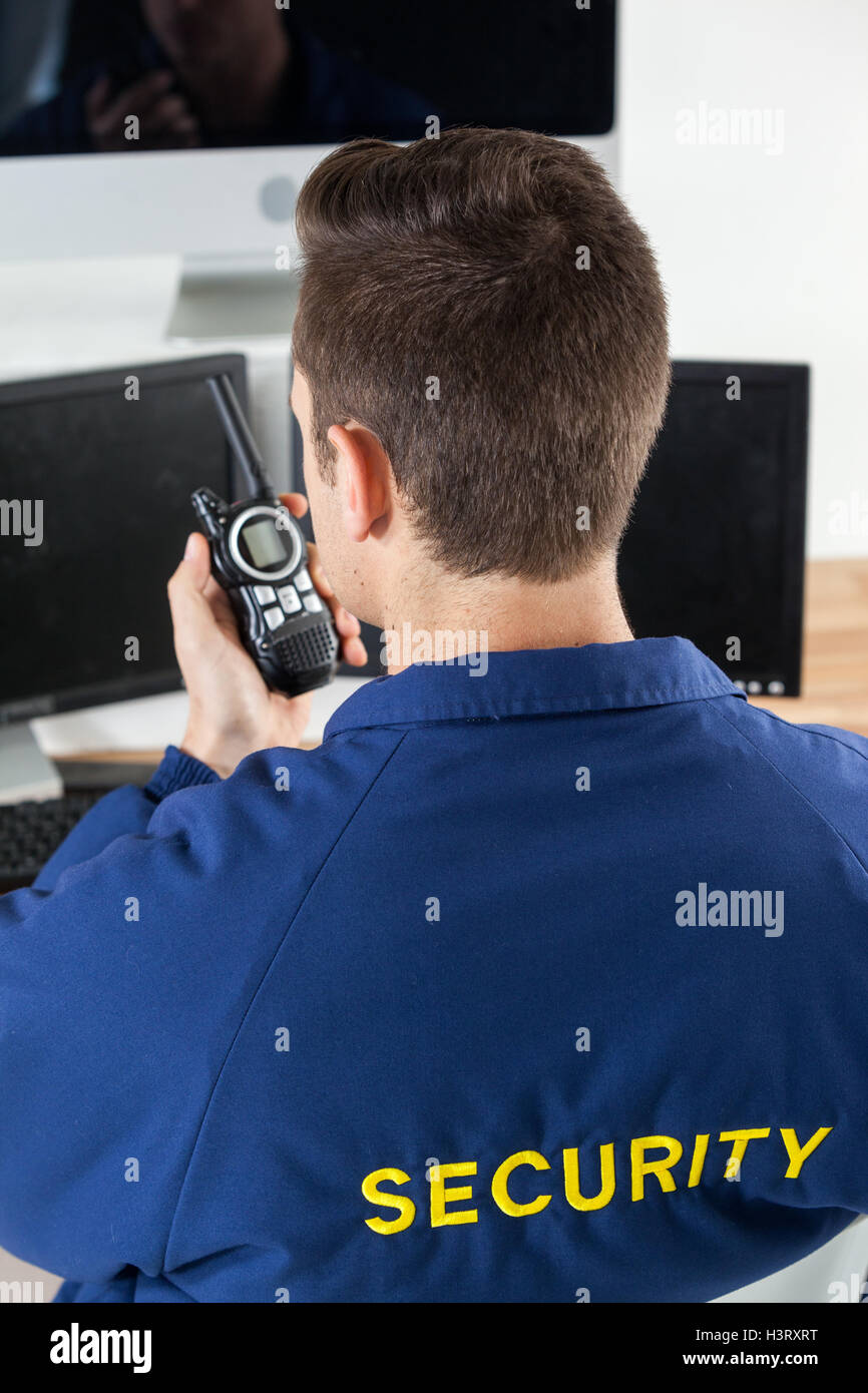 Security man looking at monitors hi-res stock photography and images ...