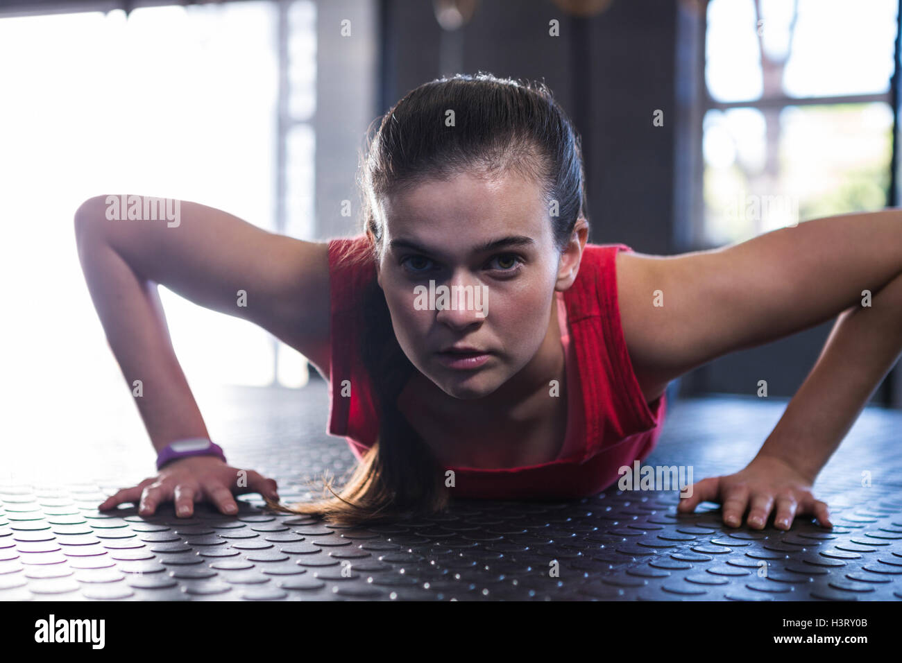 Portrait of sporty athlete doing push-ups in gym Stock Photo - Alamy