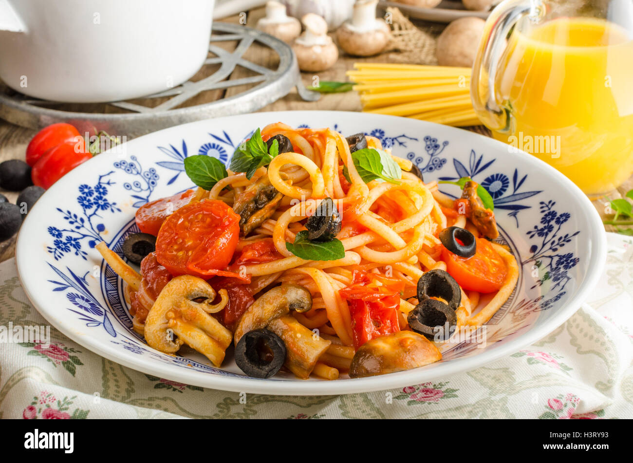 Pasta with olives, tomatoes and basil, fresh pasta, orange juice Stock ...