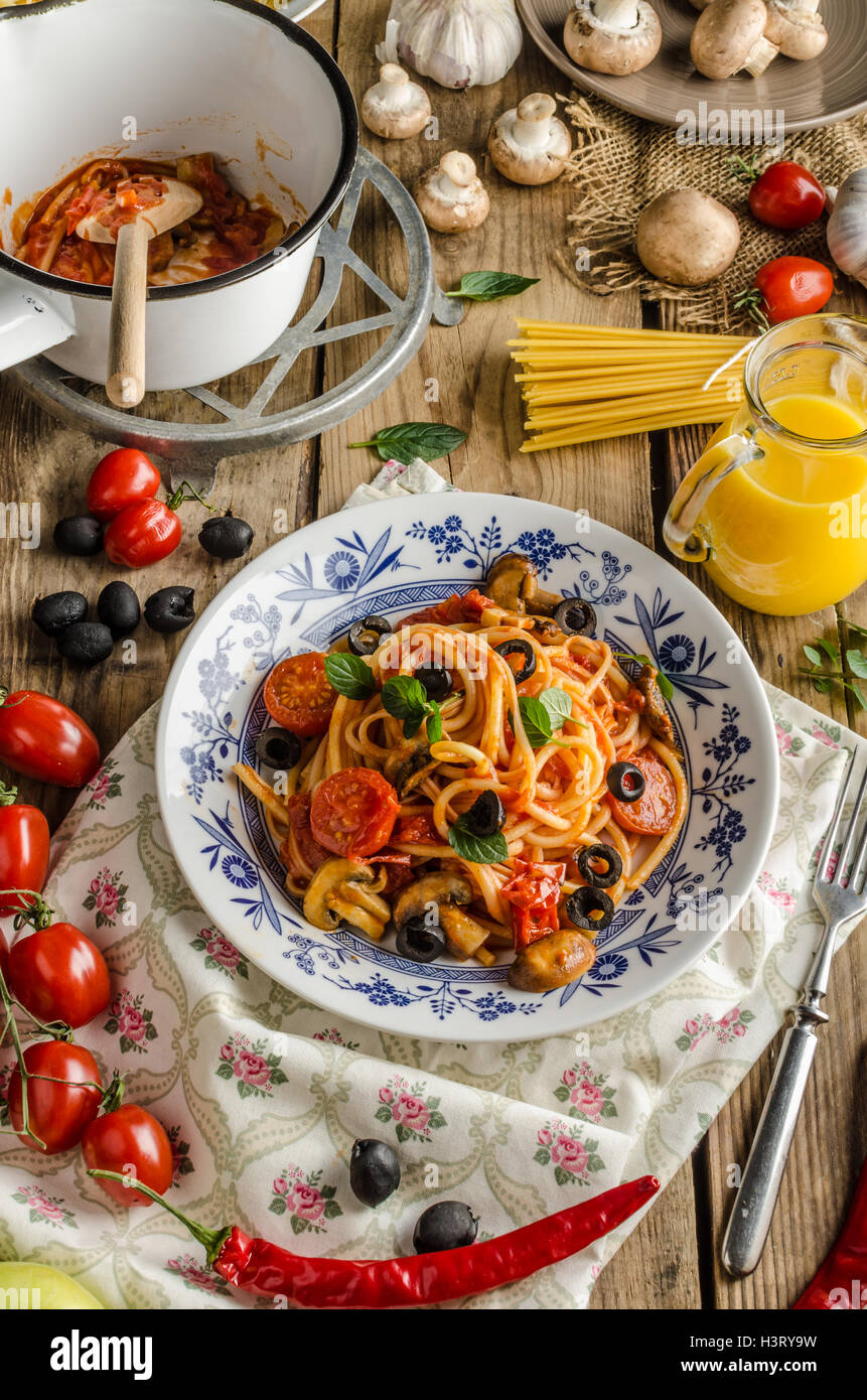 Pasta with olives, tomatoes and basil, fresh pasta, orange juice Stock ...