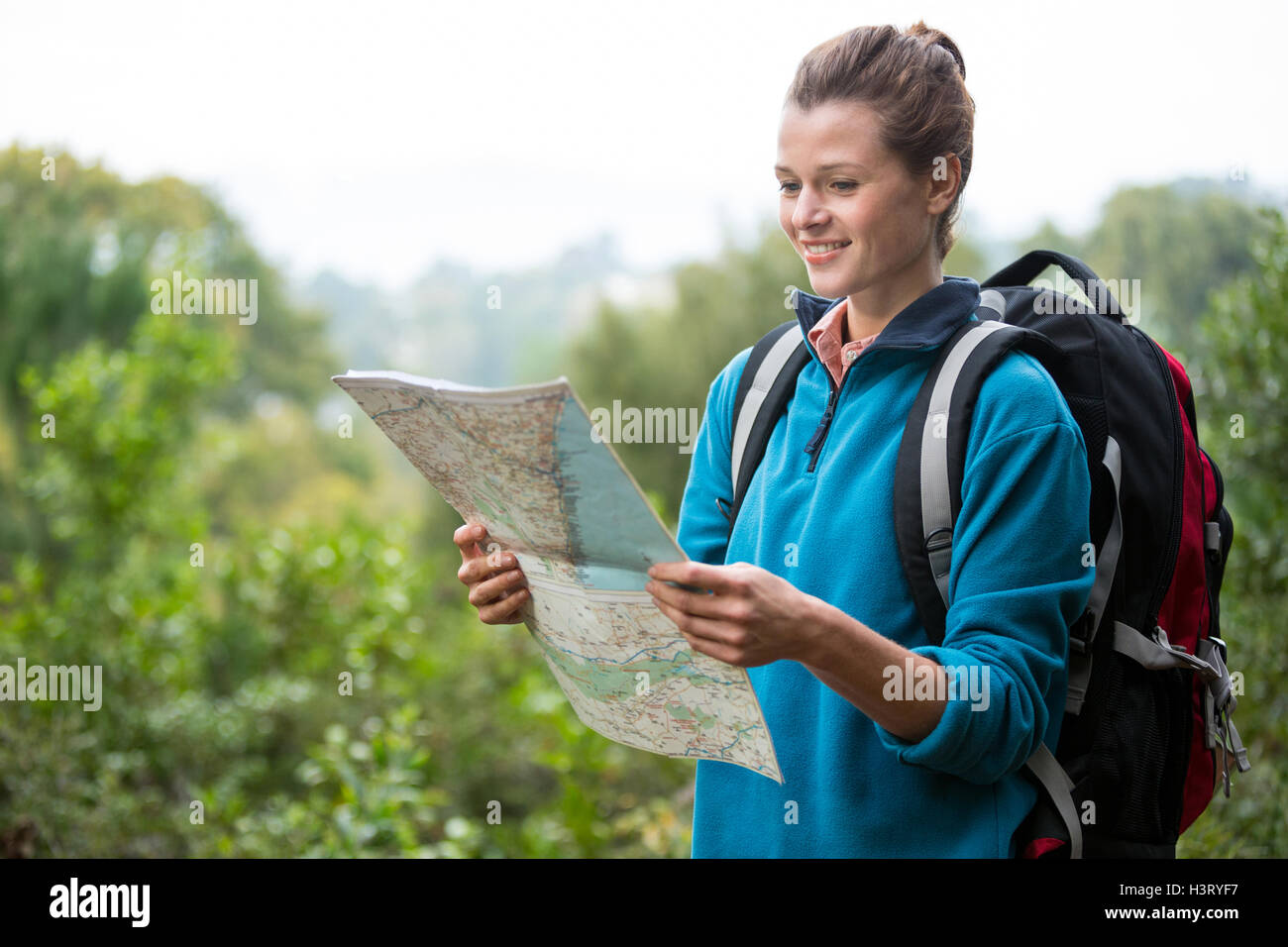 Female hiker looking at map Stock Photo - Alamy
