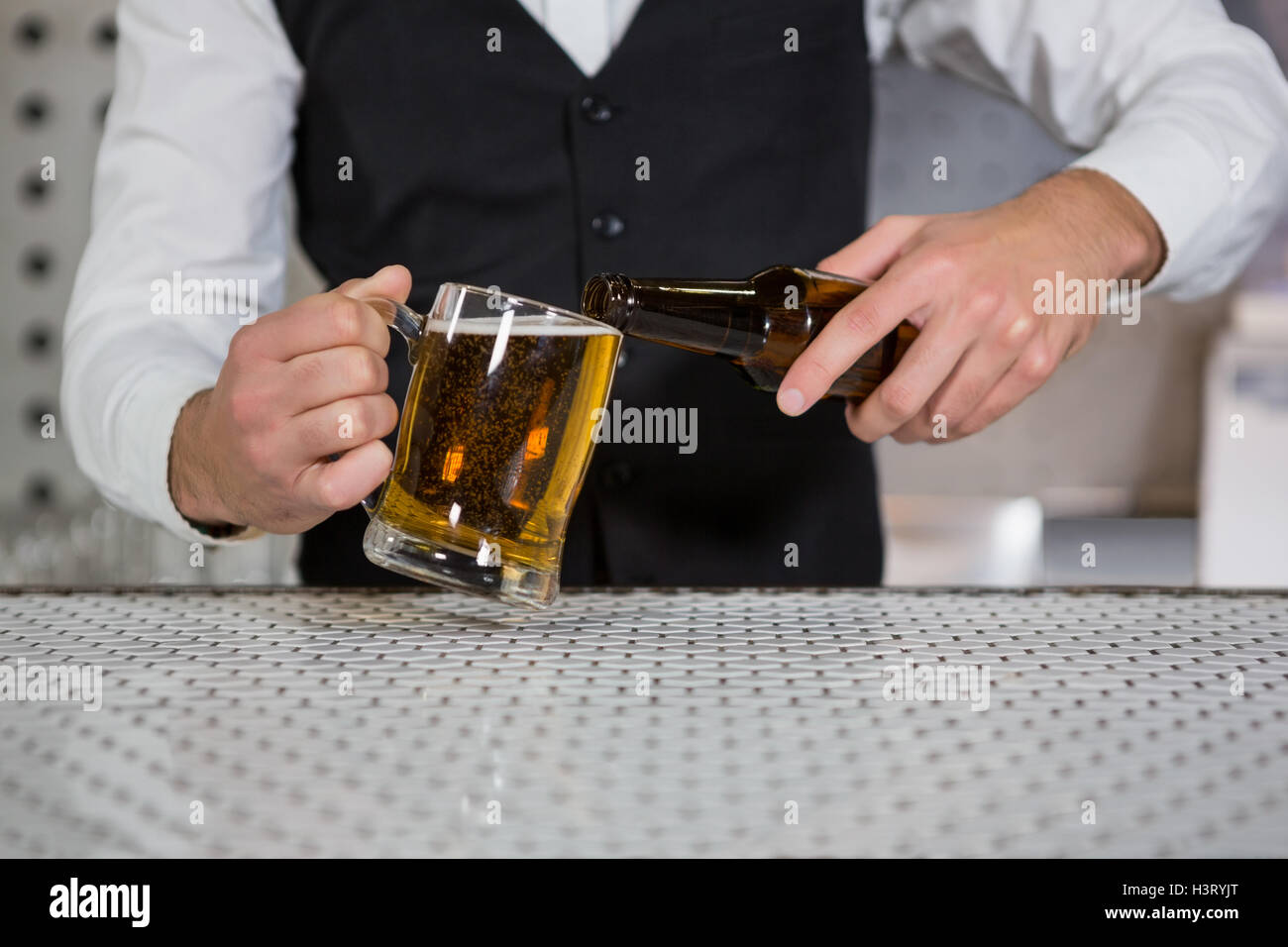 Bartender pouring beer on glass Stock Photo - Alamy