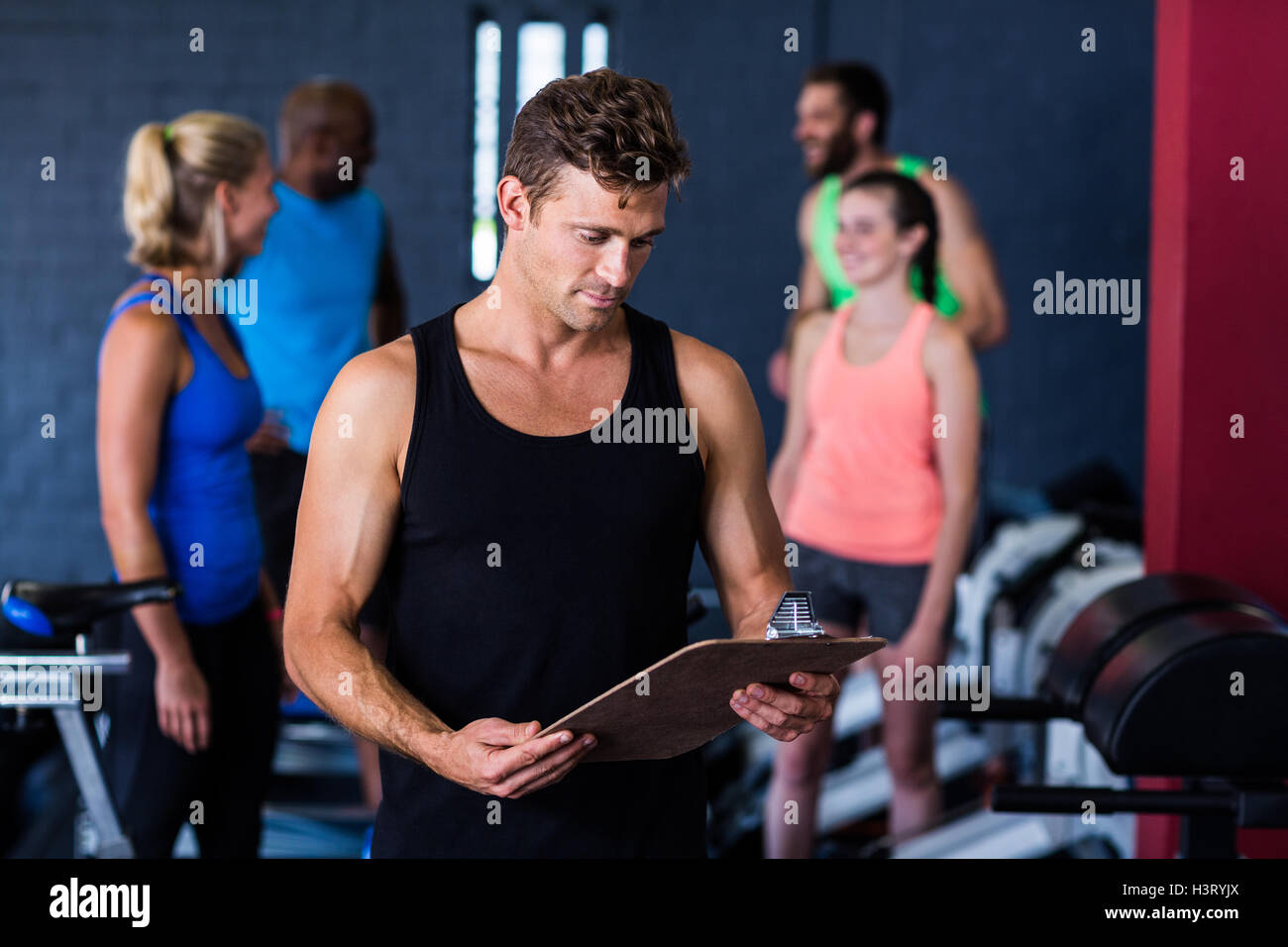 Gym trainer with clipboard Stock Photo - Alamy