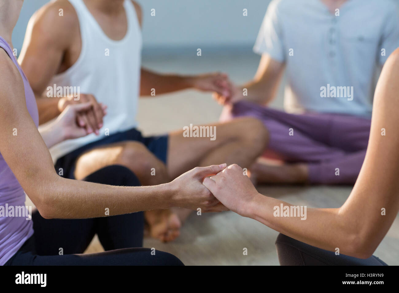 Group of people performing yoga Stock Photo - Alamy