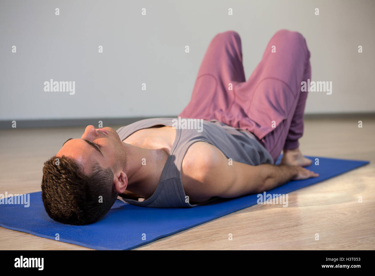 Man in yoga corpse pose Stock Photo - Alamy