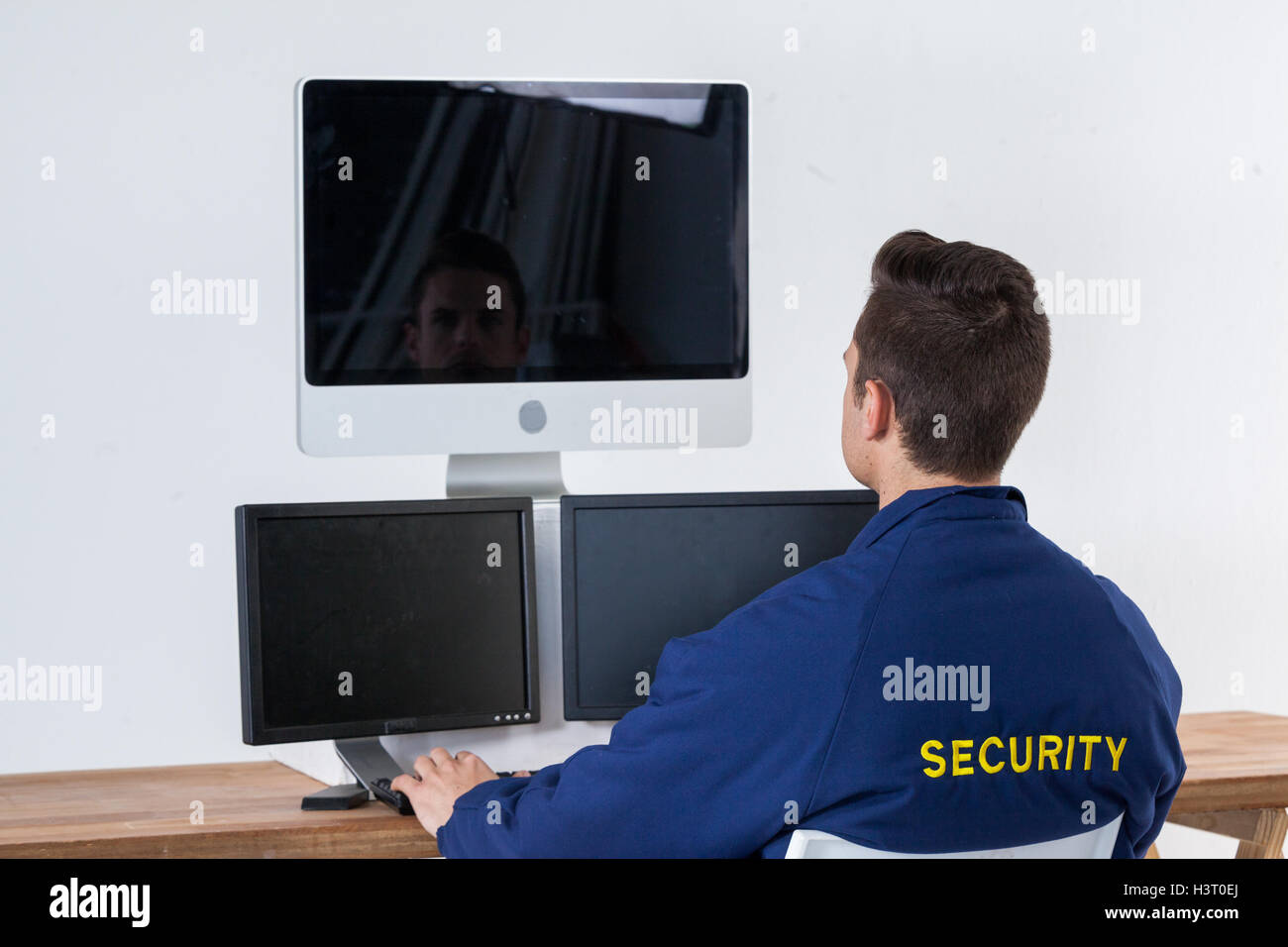 Security officer using computer Stock Photo - Alamy