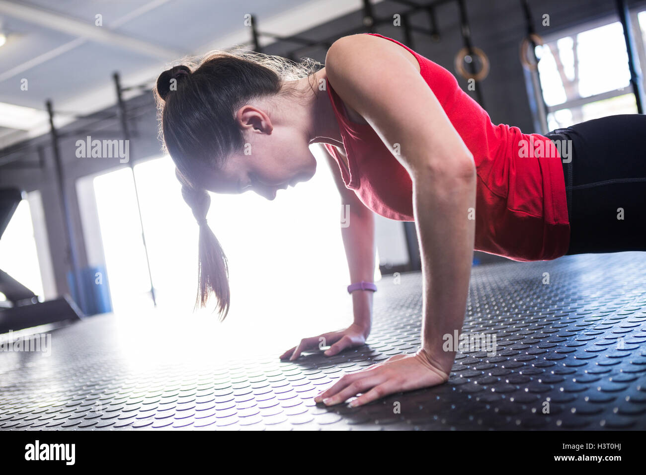 Female athlete doing push-ups in gym Stock Photo - Alamy