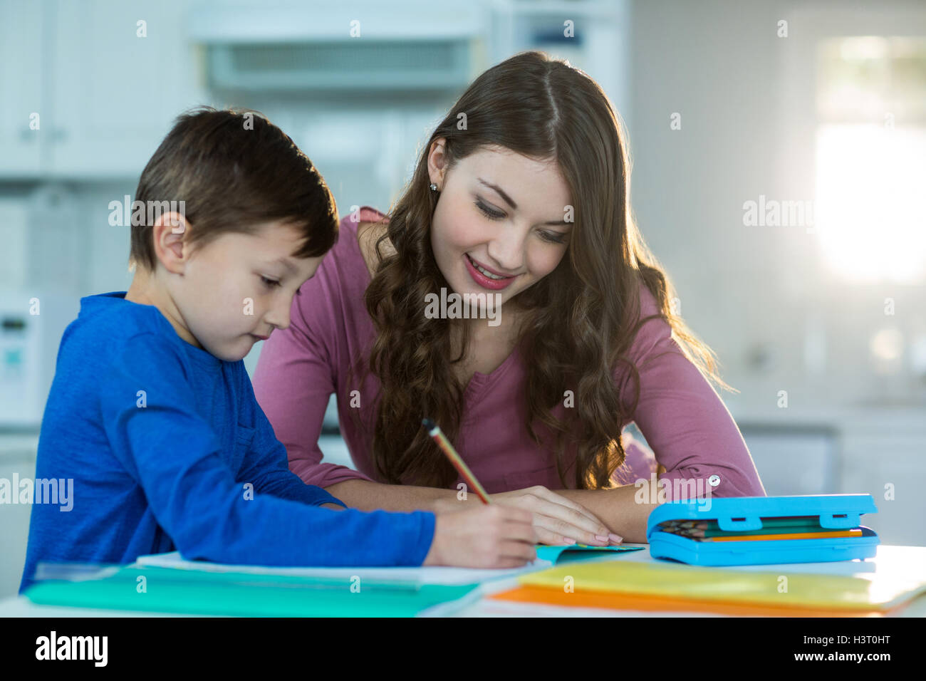 Mother helping her son with homework Stock Photo - Alamy