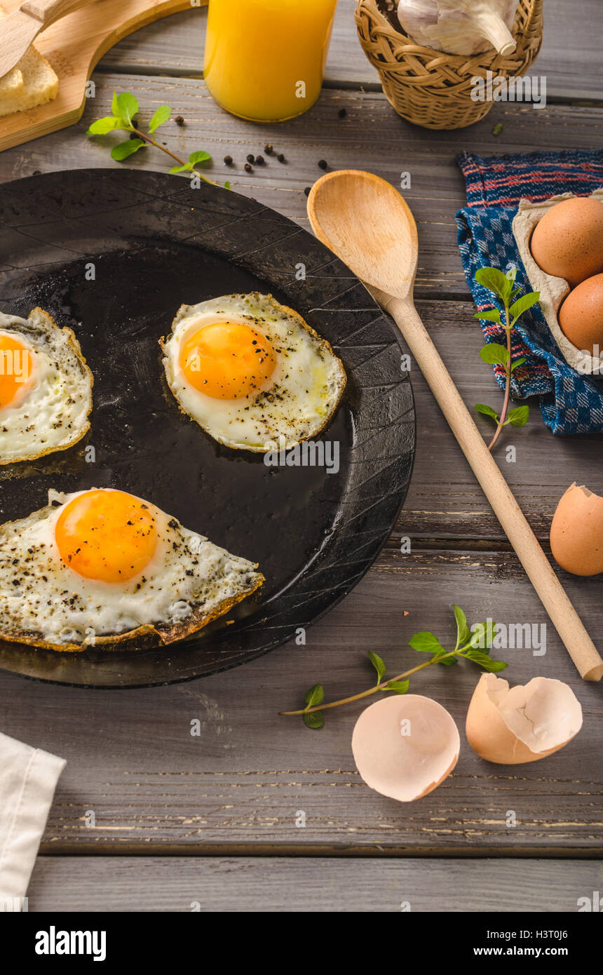 Eggs fried rustic style, bio eggs with white bread Stock Photo - Alamy