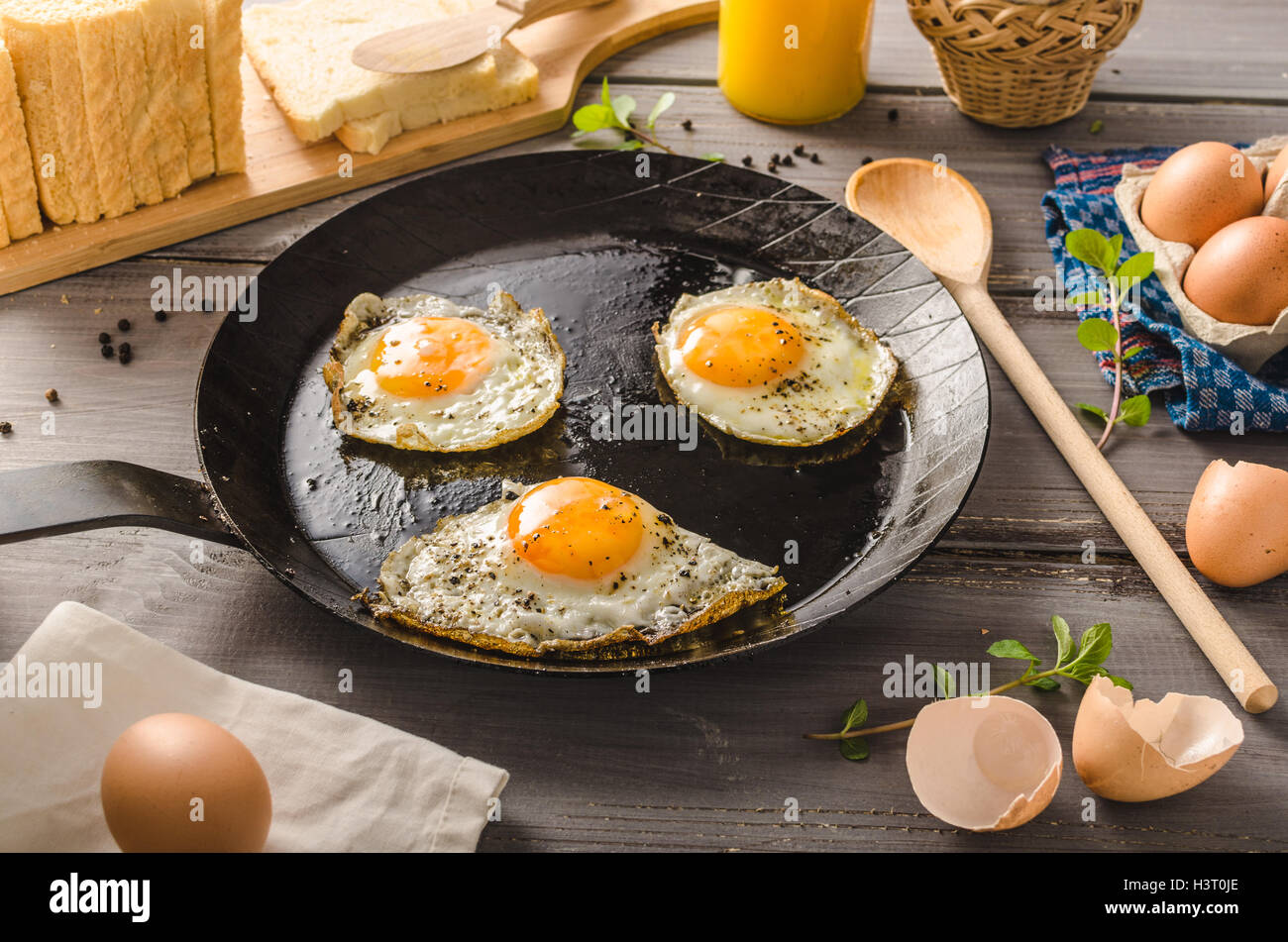 Eggs fried rustic style, bio eggs with white bread Stock Photo - Alamy