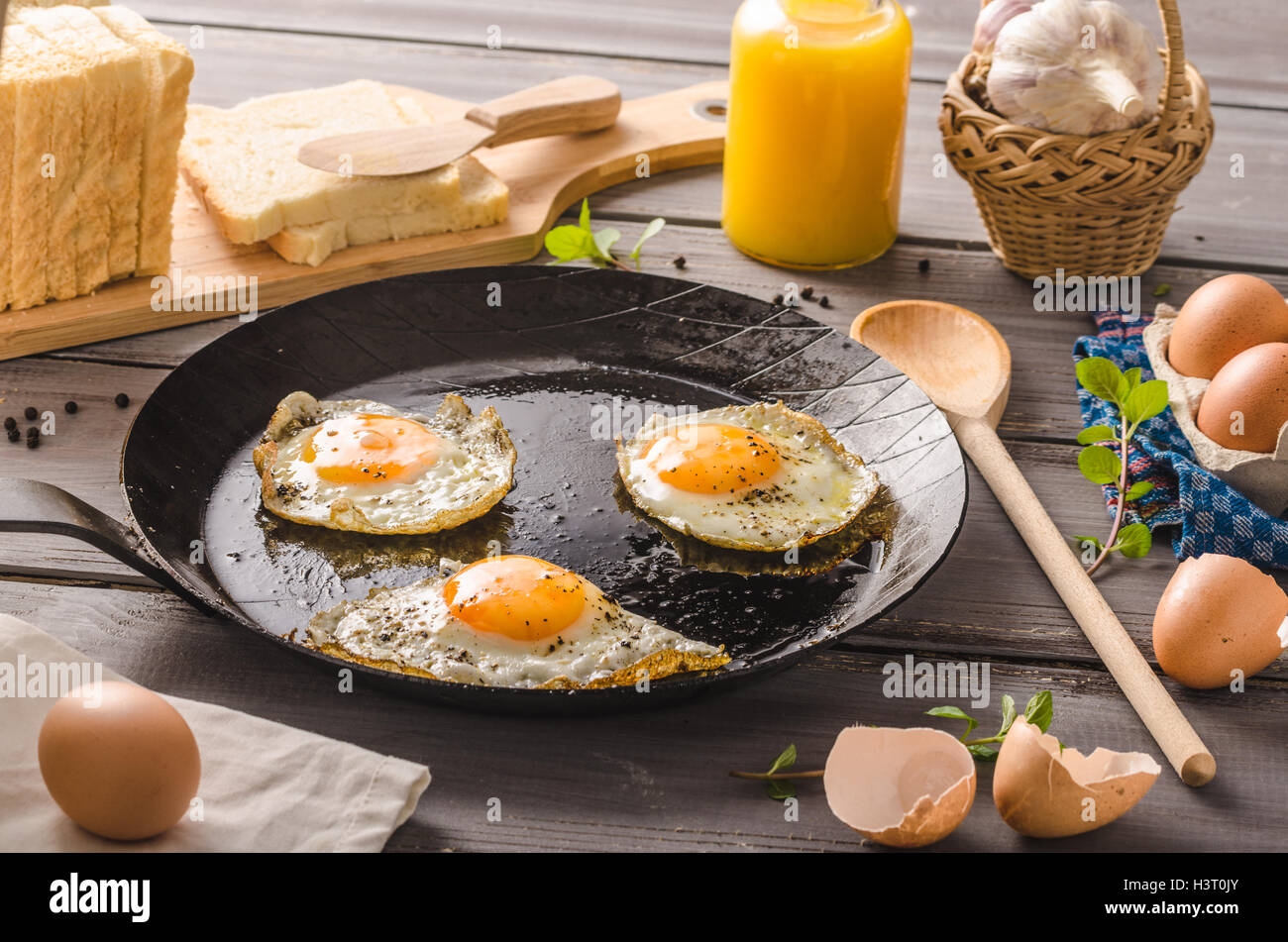 Eggs fried rustic style, bio eggs with white bread Stock Photo - Alamy