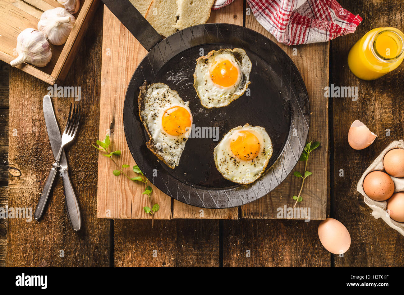 Eggs fried rustic style, bio eggs with white bread Stock Photo - Alamy