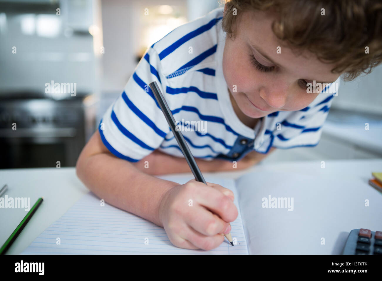 Boy doing his homework Stock Photo - Alamy